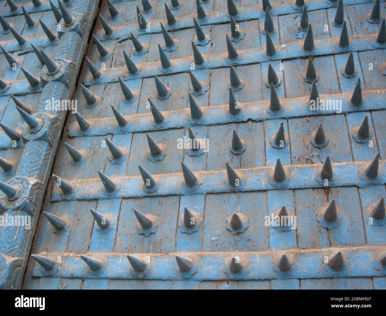 The gate in the old Indian fortress. On the gate there are metal spikes ...