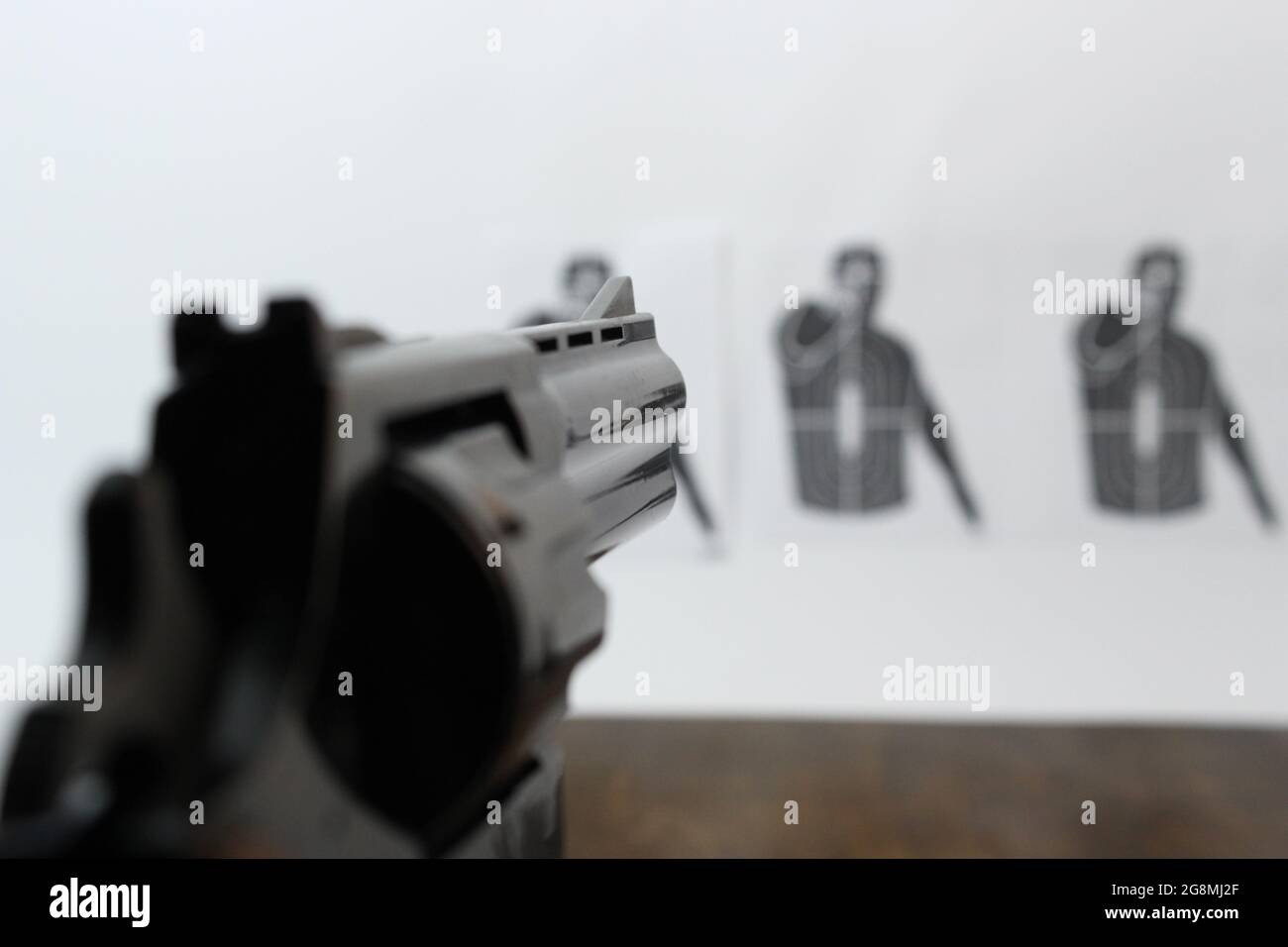 The revolver is aimed at the shooting target. A terrorist is depicted ...