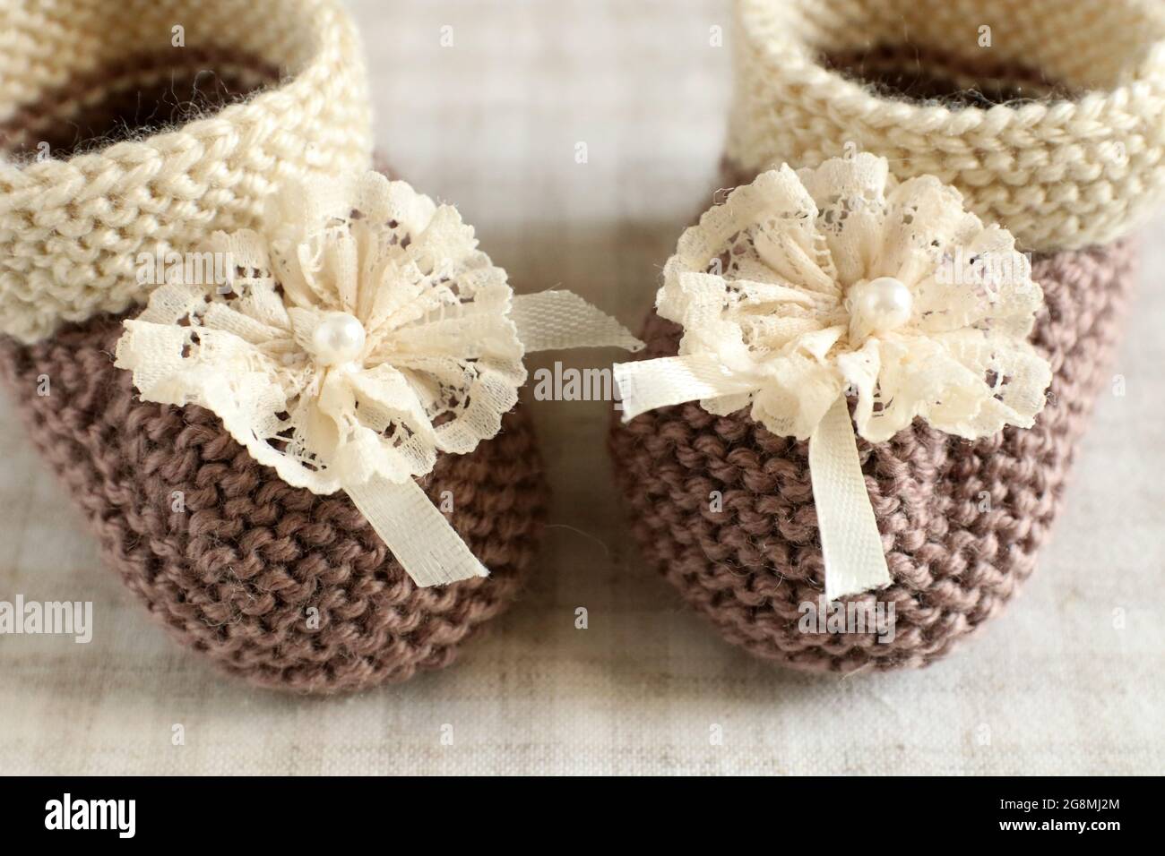 Handmade baby booties are knitted. Booties with a bow Stock Photo - Alamy