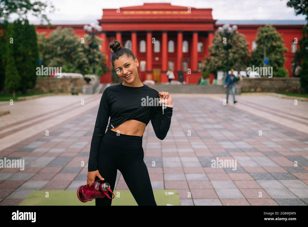 Fitness model in sportswear posing on the city street Stock Photo - Alamy