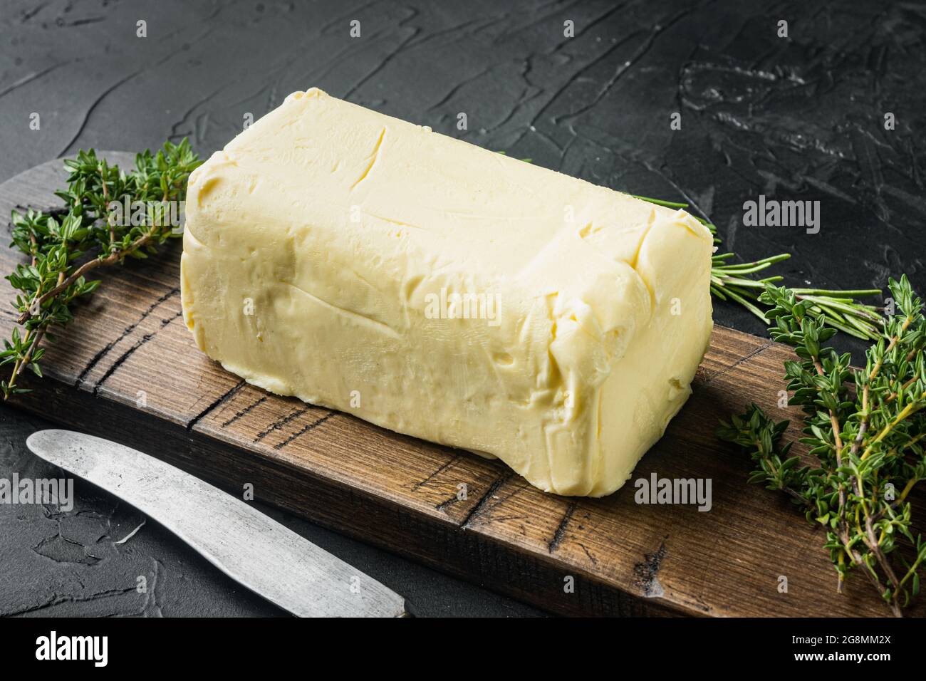 White butter fresh brick, on black background Stock Photo - Alamy