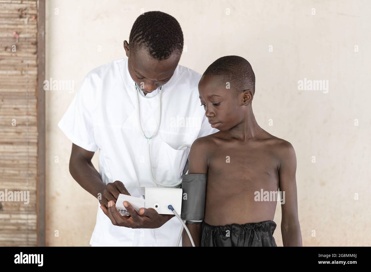 This is an image of an African male nurse working in a hospital with a ...