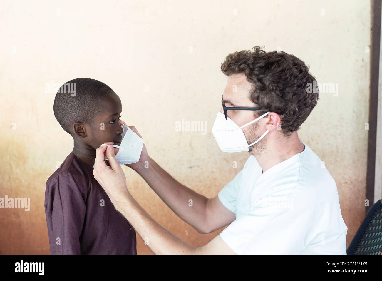 This is an image of a white caucasian volunterring doctor helping a ...