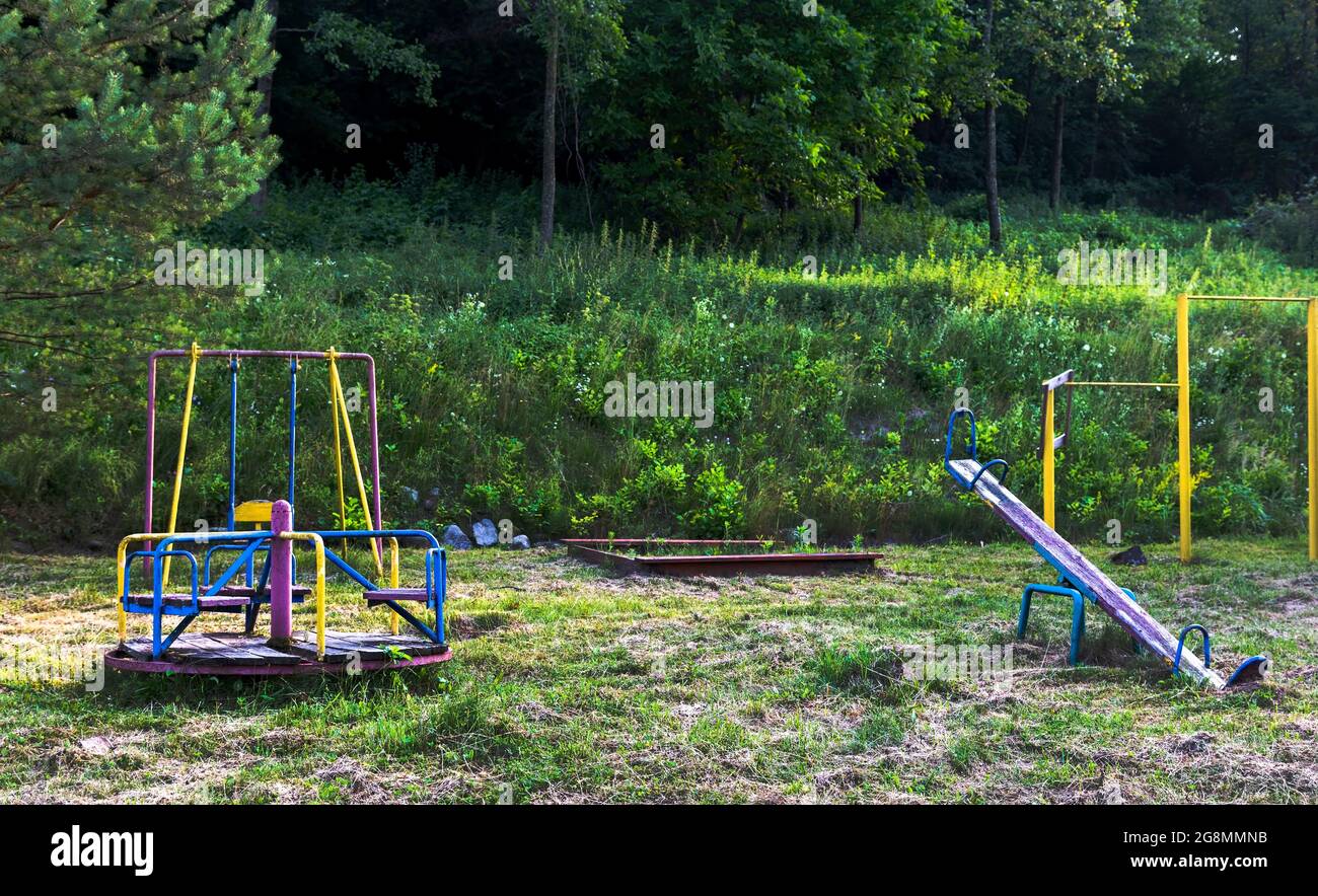 Old, abandoned playground, without children, swing, carousel, sandbox ...