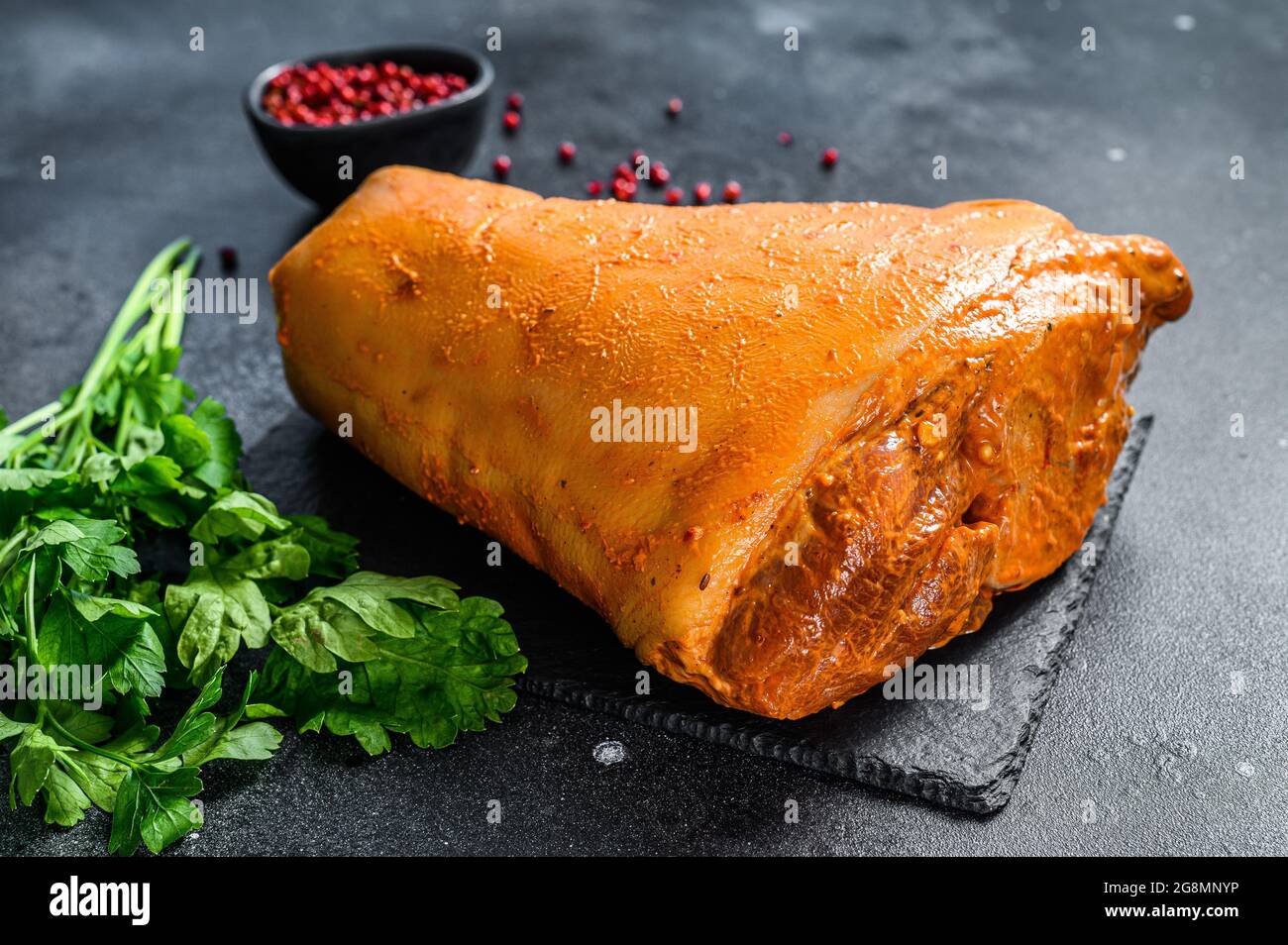 Raw pork leg with herbs and marinate on table. Black background. Top ...