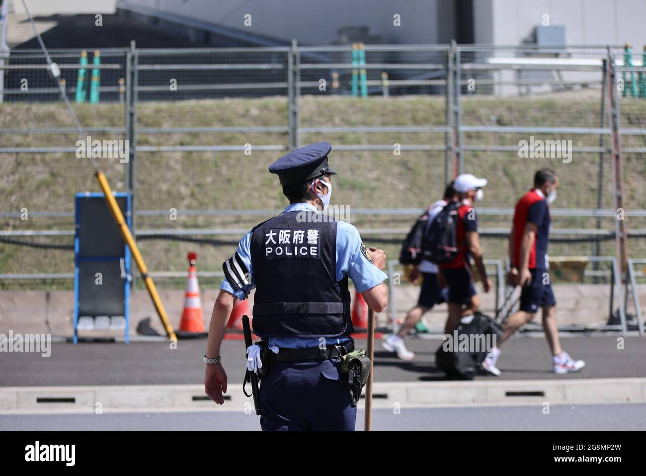 Police officer watches over French Olympic Team members as they enter ...