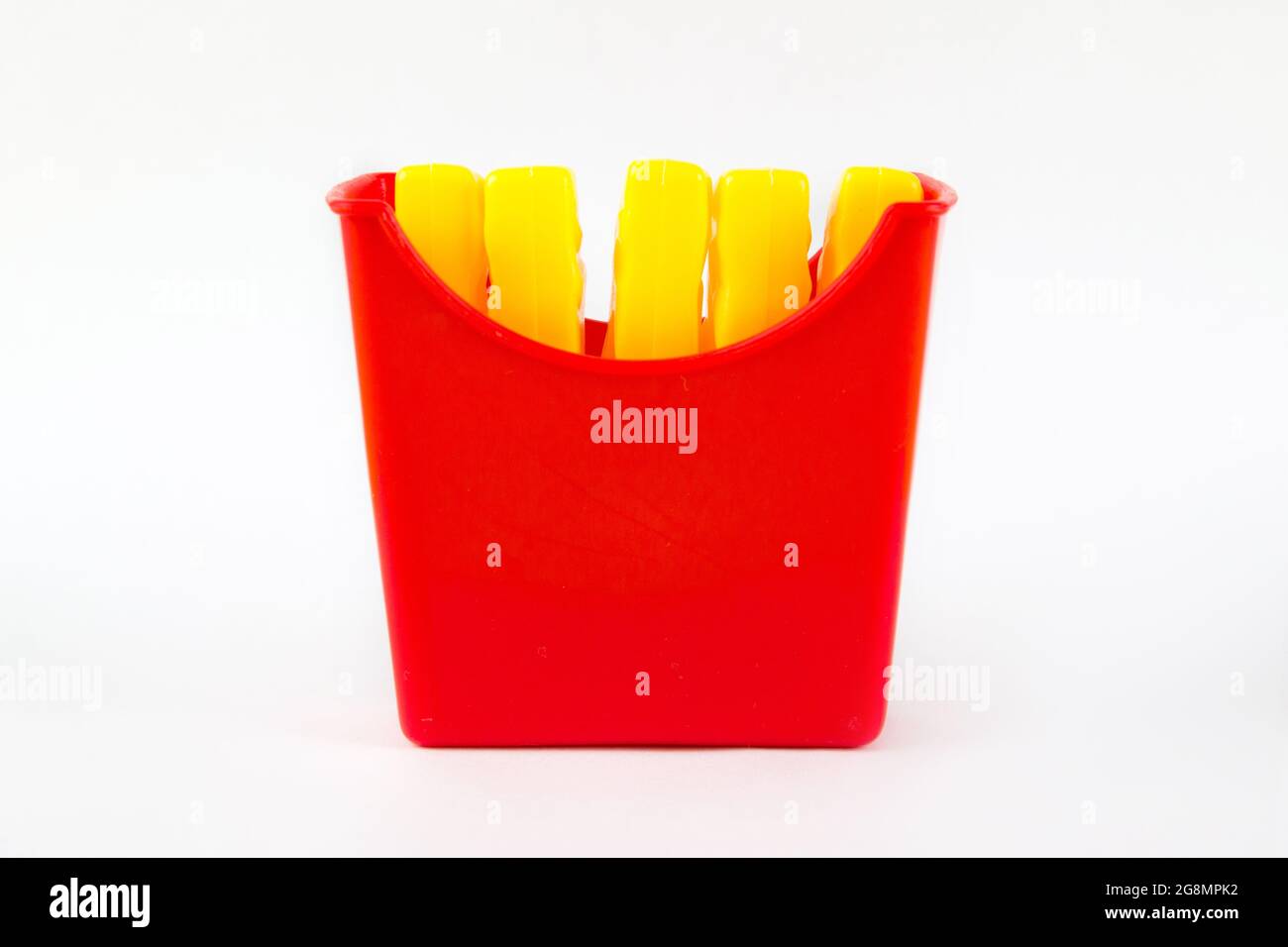 Miniature potato fried toy, toy plastic French fries on white ...