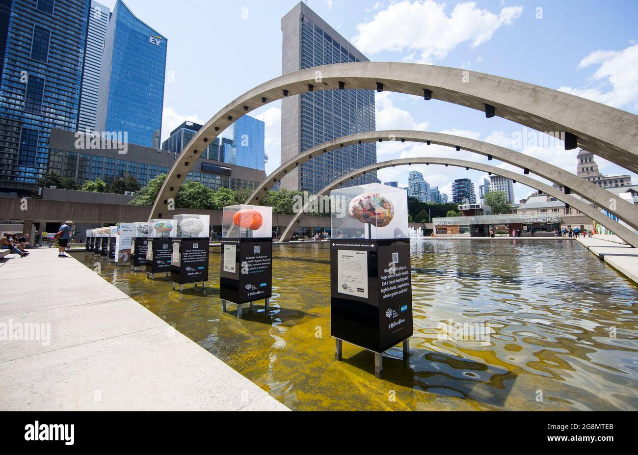 Toronto, Canada. 21st July, 2021. People look at brain sculptures at ...