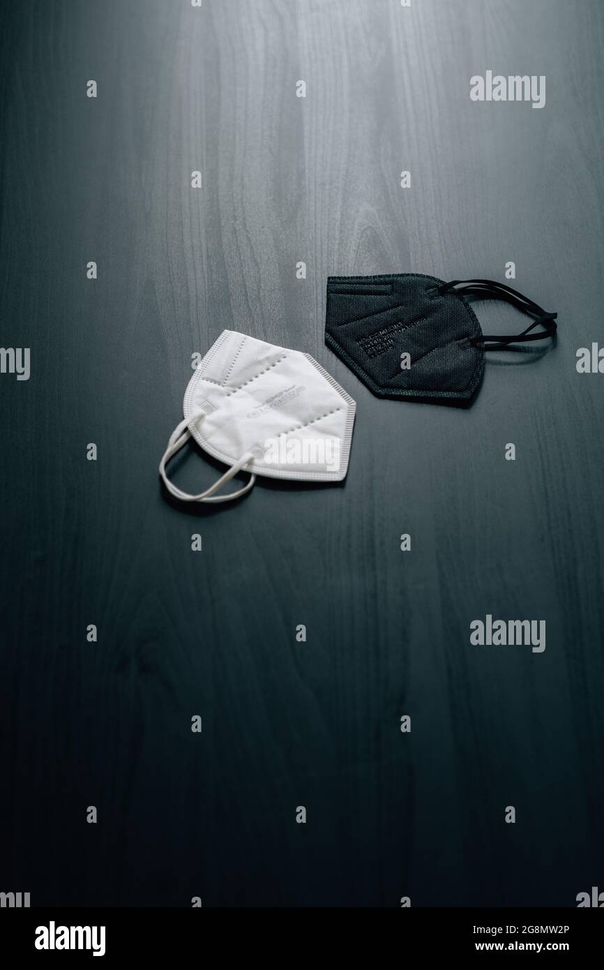 Vertical top view of white and black facial masks on a table Stock ...