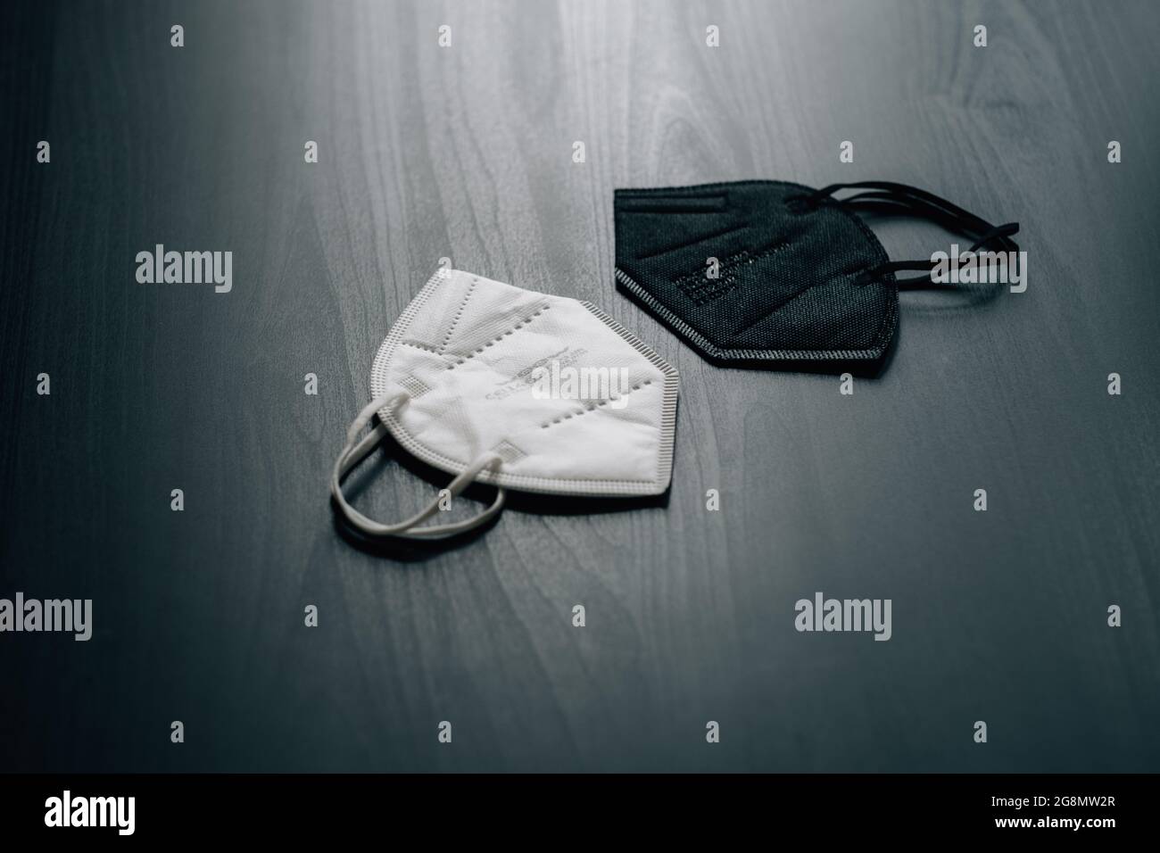 Top view of white and black facial masks on a table Stock Photo - Alamy