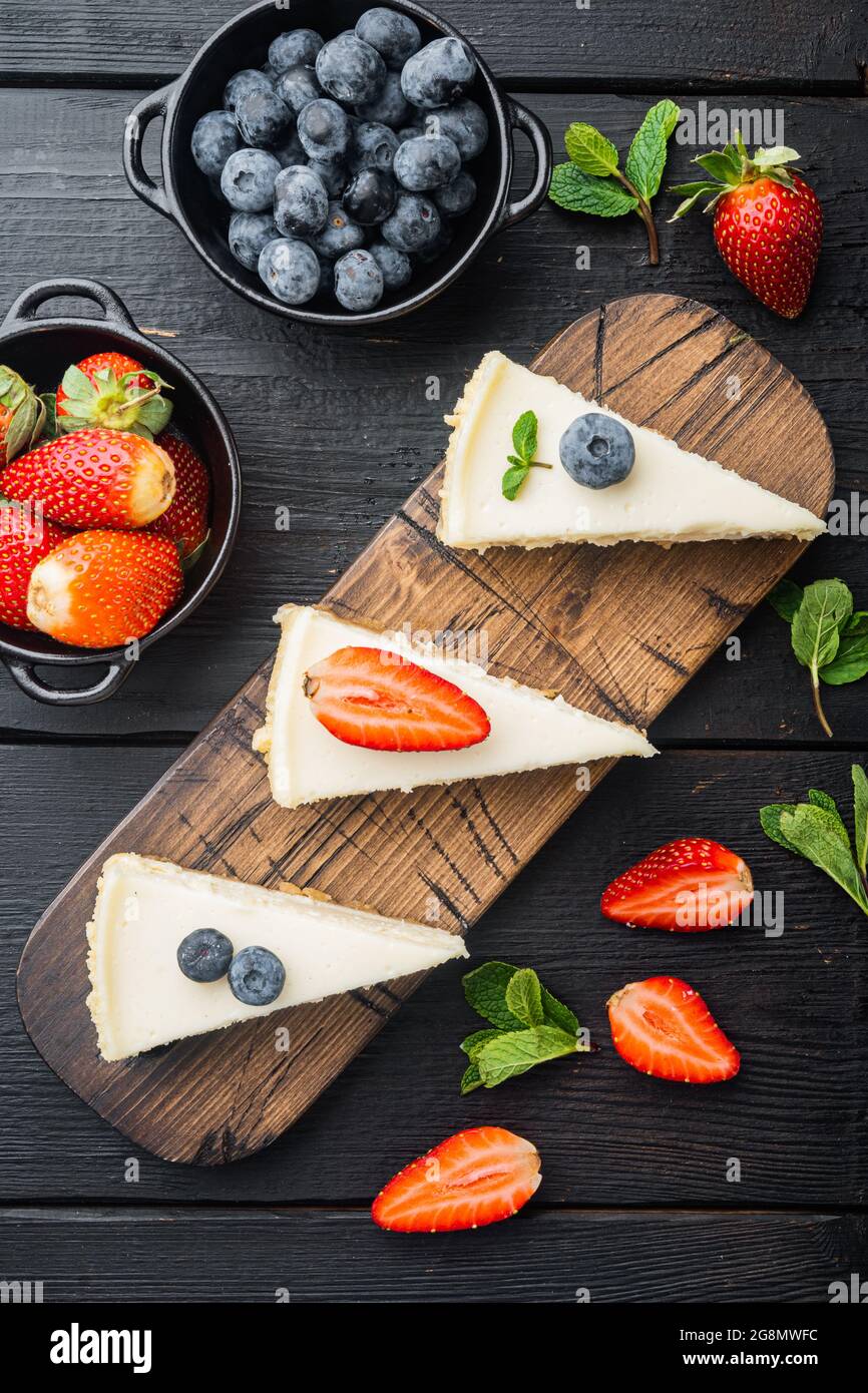 Slices Of Classical New York Cheesecake, on black wooden table ...