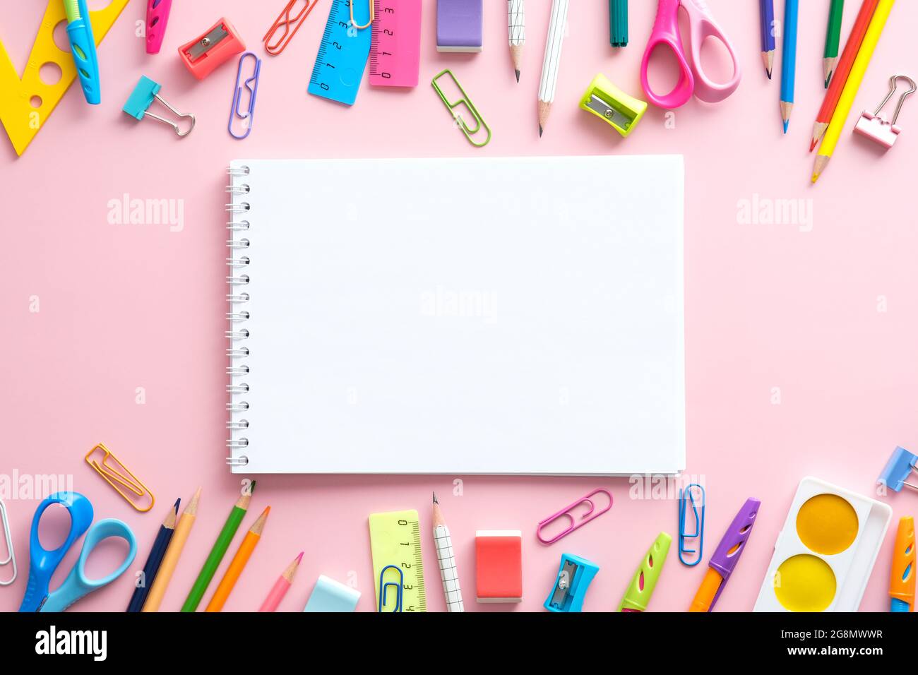 School supplies and blank paper notepad on pink background. Back to ...