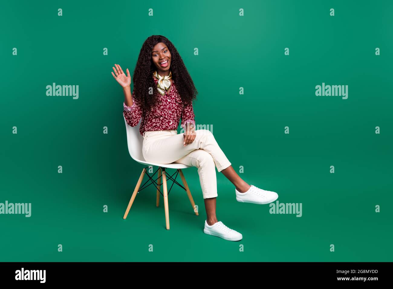 Photo of pretty sweet curly dark skin woman dressed red shirt sitting ...