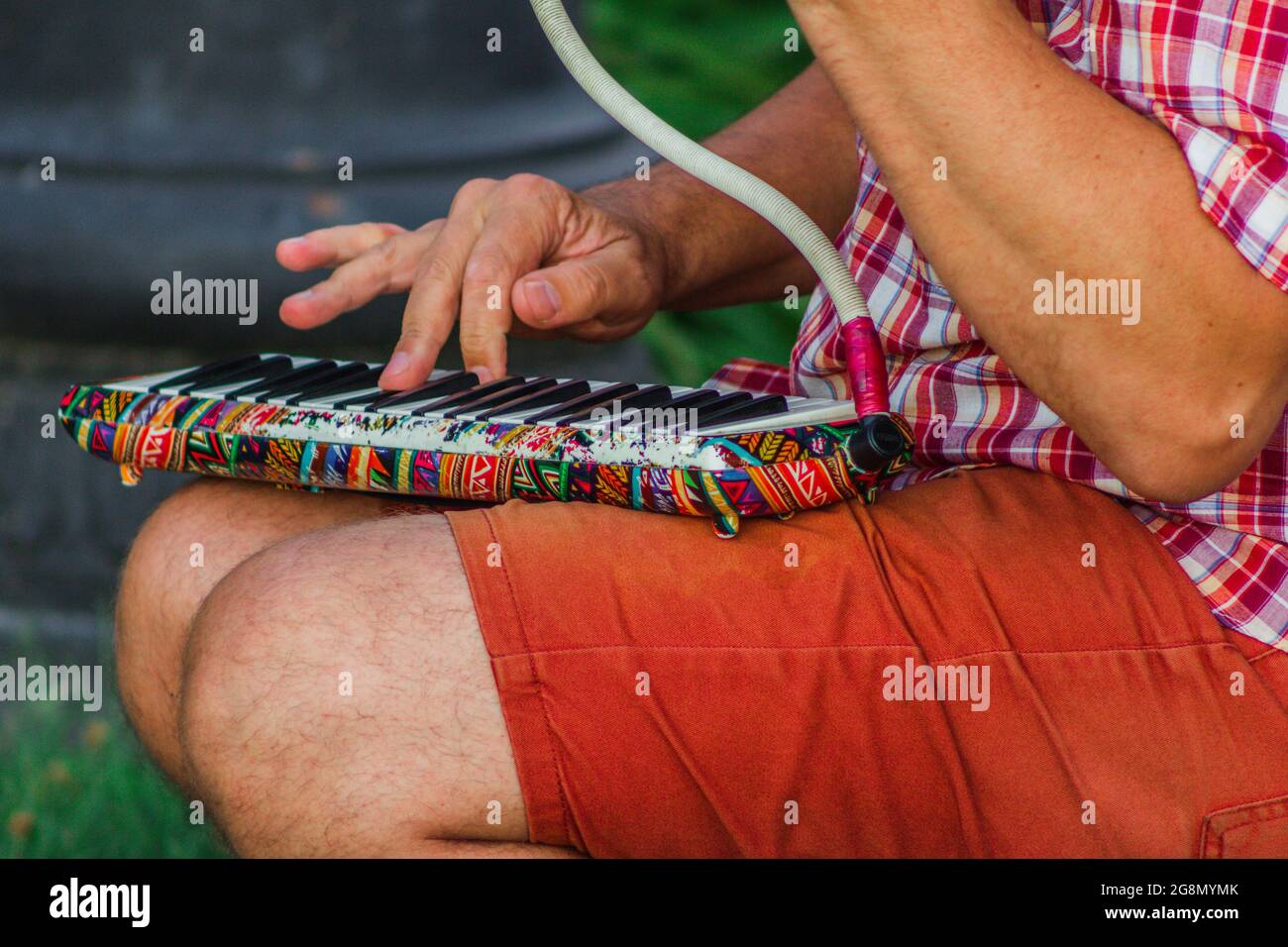 musician plays on Melodica artist keyboard blow Stock Photo - Alamy