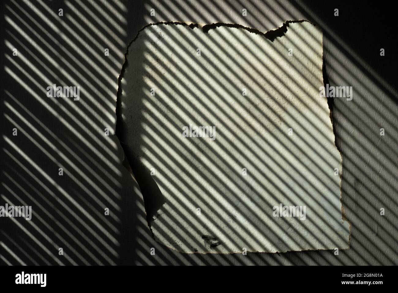 Closeup of sun rays falling on a torn wallpaper on the wall Stock Photo ...