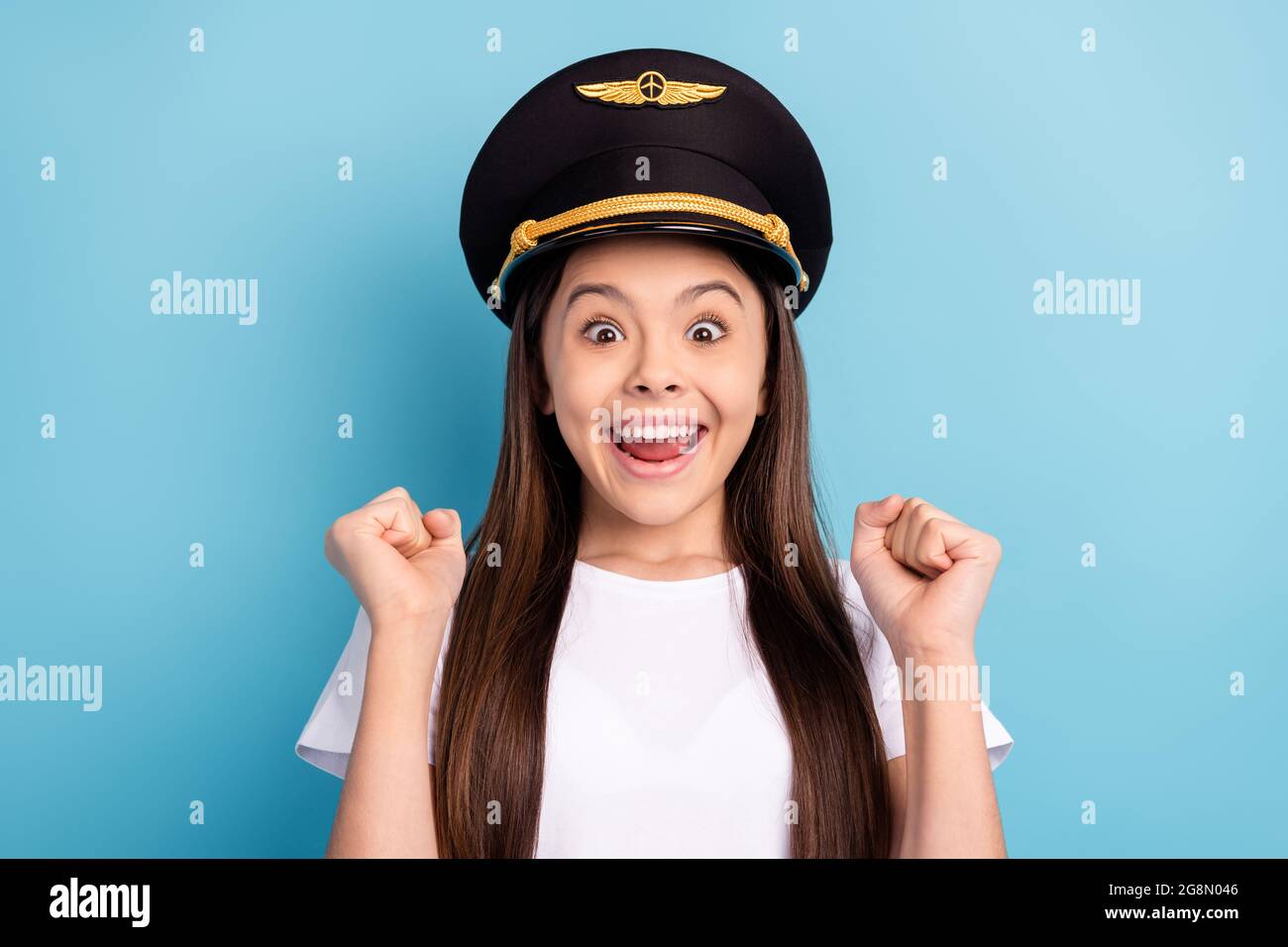 Portrait of attractive cheerful amazed girl captain wearing hat ...