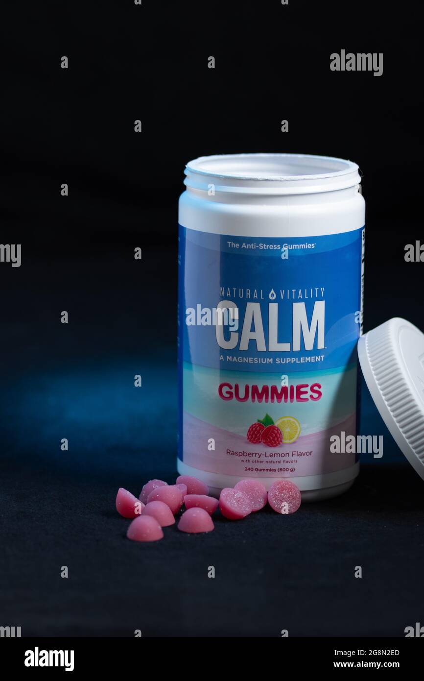 Plastic container of Calm magnesium dietary supplement on dark ...