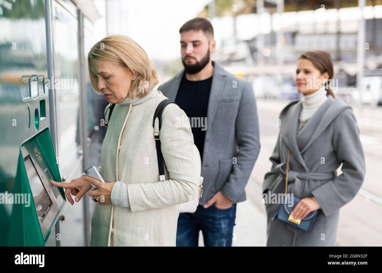 Woman traveler buying ticket at ticket vending machine Stock Photo - Alamy