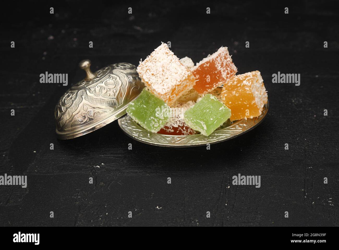 Turkish delight dessert in plate on black background Stock Photo - Alamy