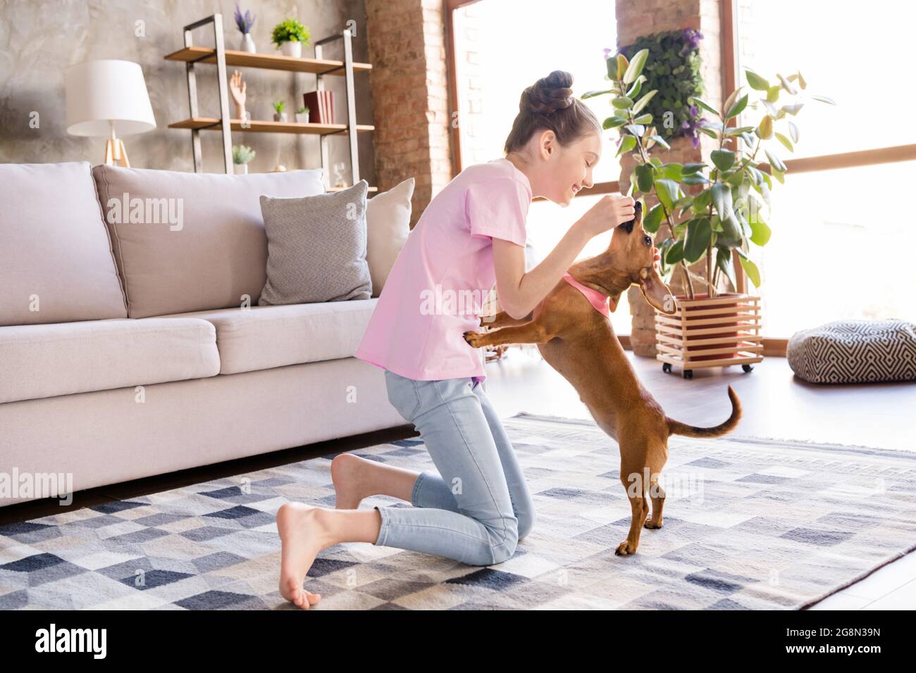 Photo of cute funny small schoolgirl dressed pink t-shirt treating ...