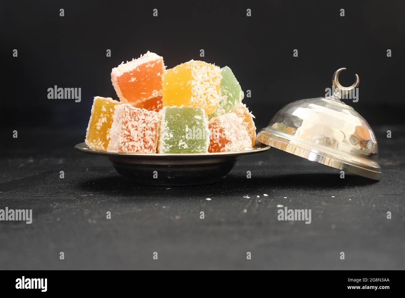 Turkish delight dessert in plate on black background Stock Photo - Alamy