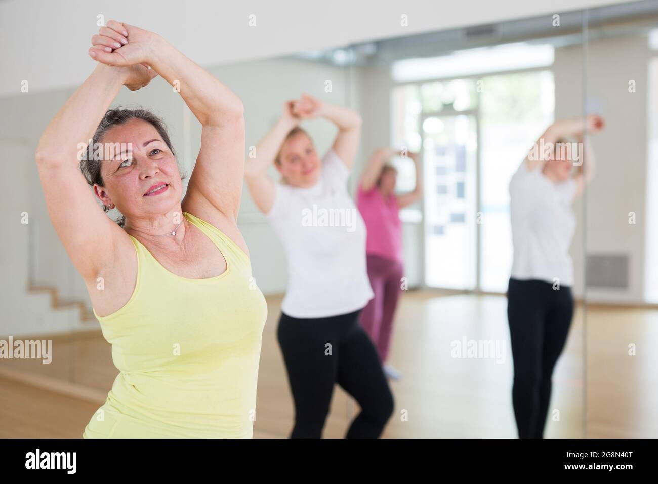 Mature woman training at group dance class Stock Photo - Alamy