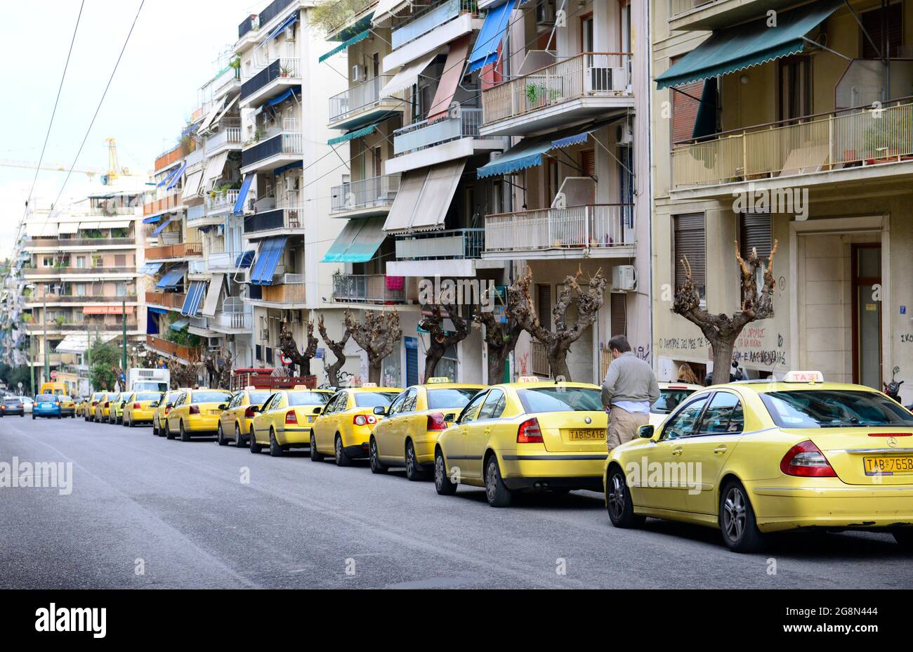 A long line of taxis on Zacharitsa street in Athens, Greece Stock Photo ...