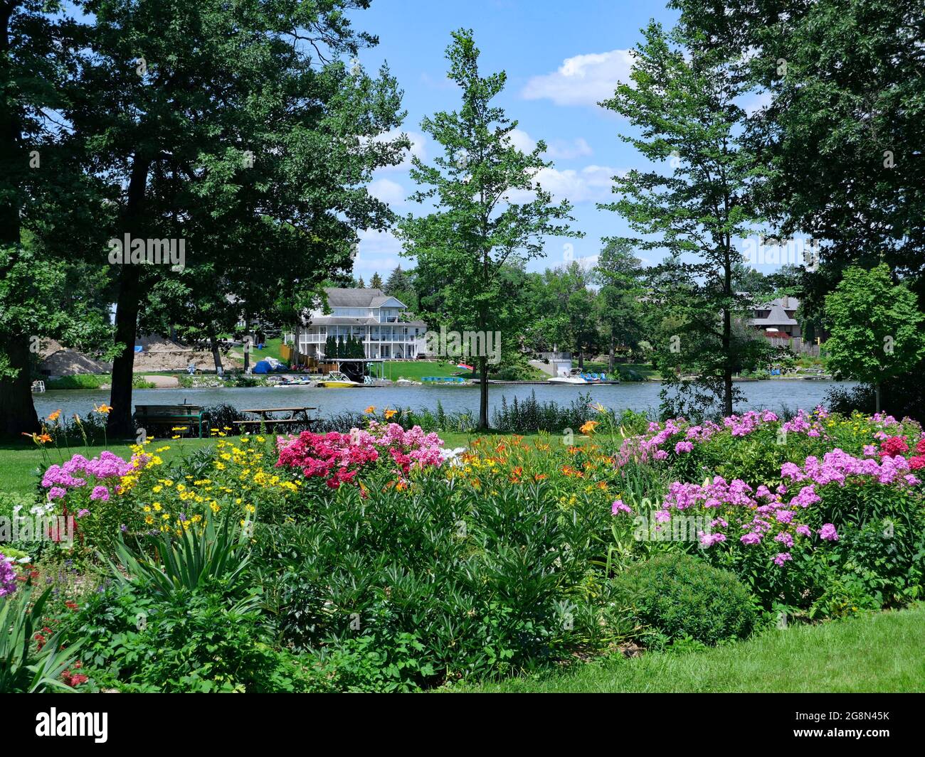 Beautiful flower garden beside lake in summer Stock Photo - Alamy