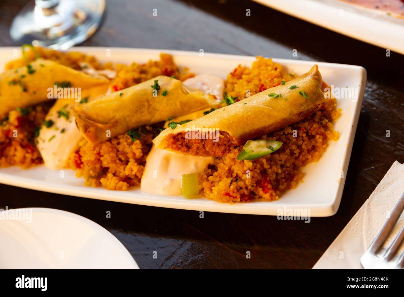 Tasty Moroccan lamb spring roll with harissa and couscous Stock Photo ...