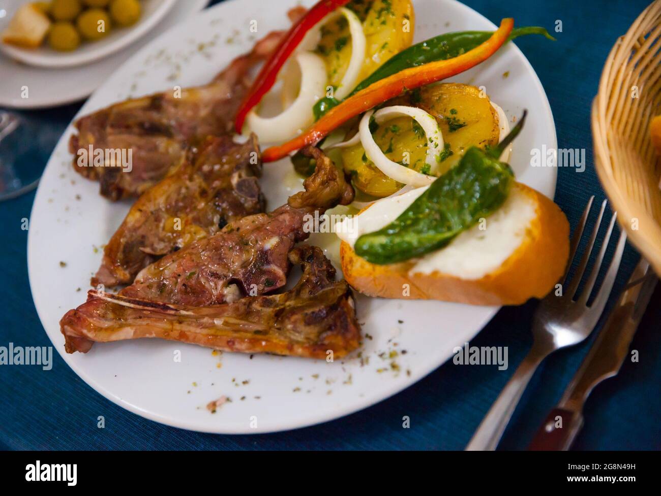 Image of tasty lamb baked and served with bread and vegetables Stock ...