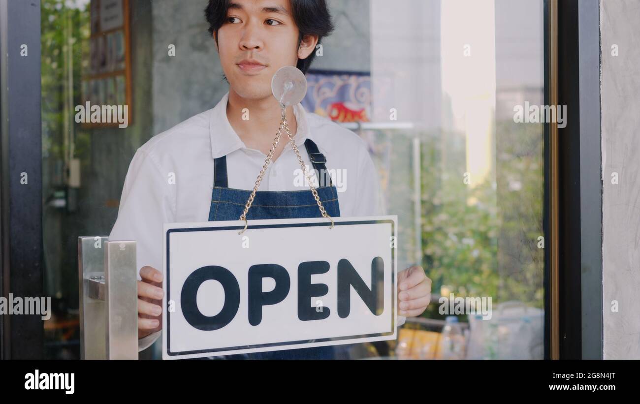 Man turning close sign to open sign hi-res stock photography and images ...
