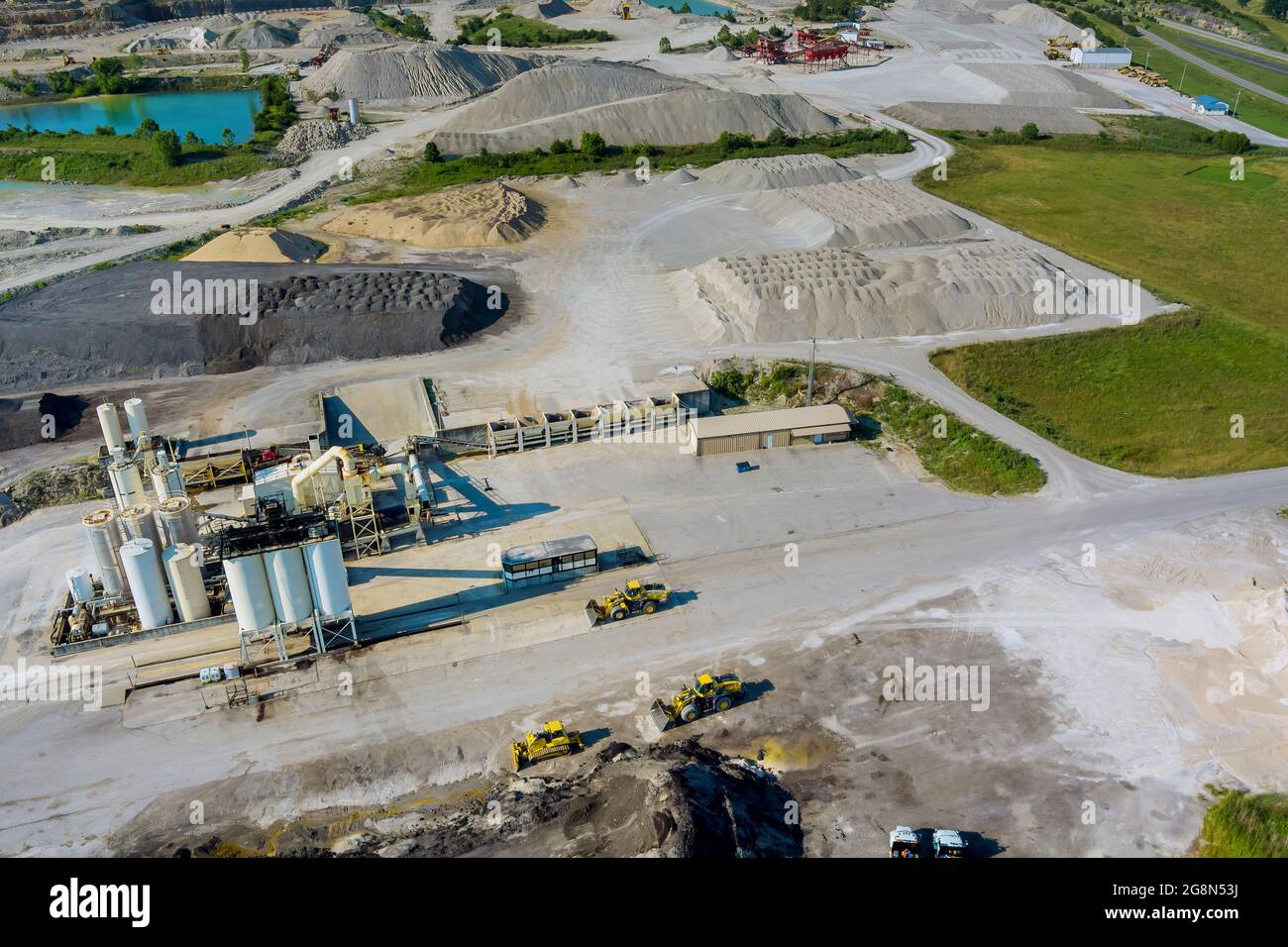 Aerial view from above of open cast mining quarry with machinery at ...