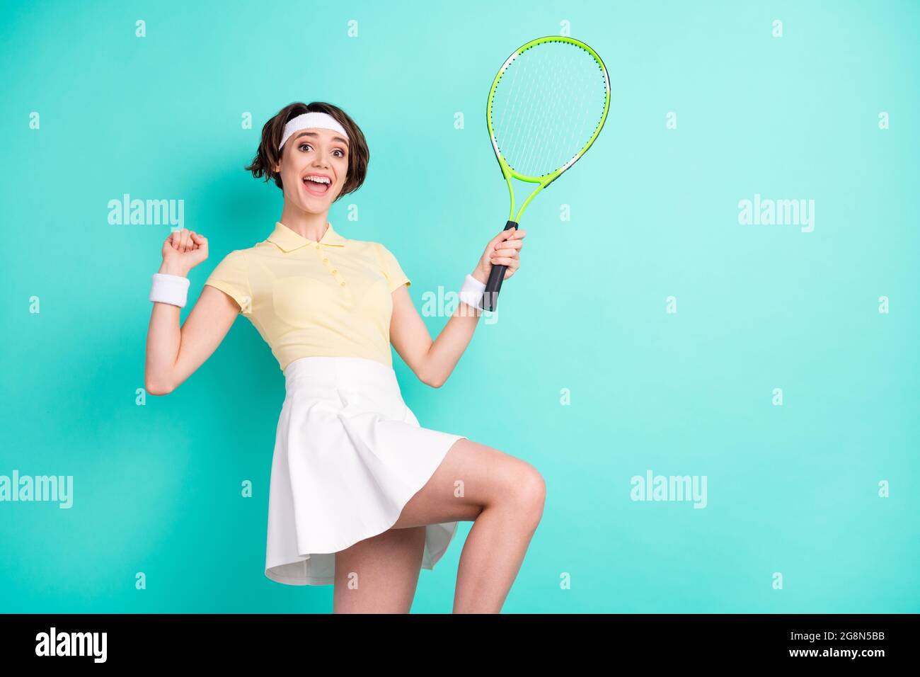 Photo of positive amazed excited young lady raise racket fist win match ...