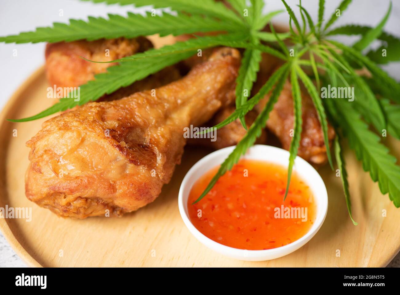 Cannabis food nature herb concept, Fried chicken leg on plate with ...
