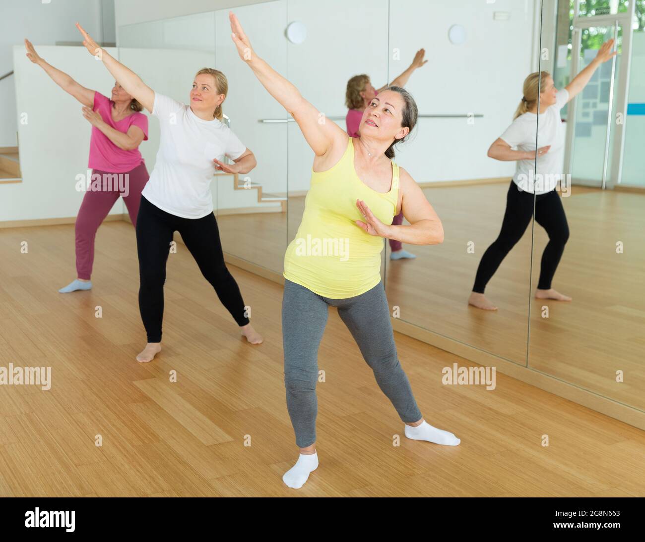 Mature women training at group dance class Stock Photo - Alamy
