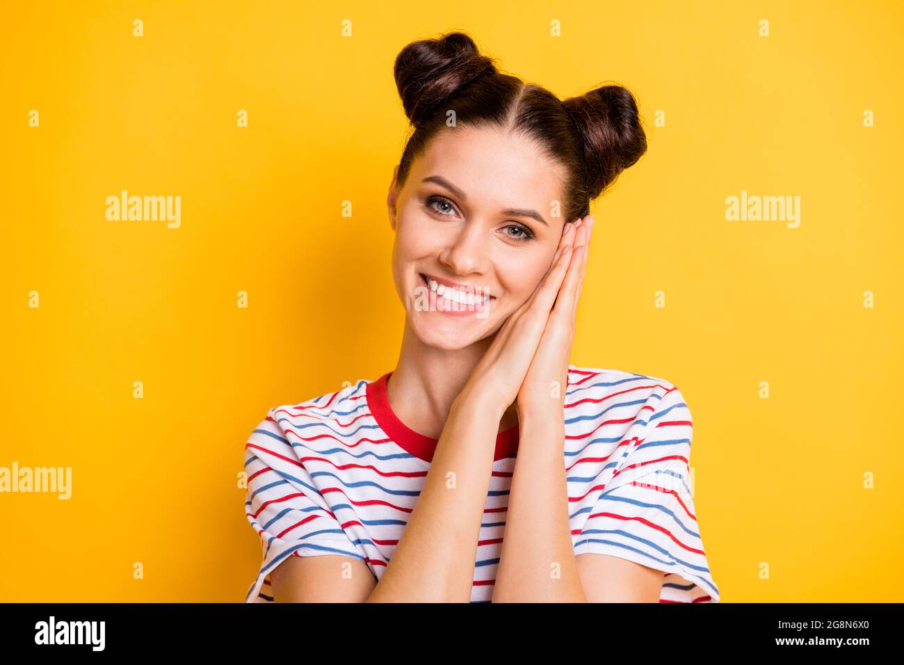 Photo of optimistic brunette lady hands cheeks wear colorful t-shirt ...