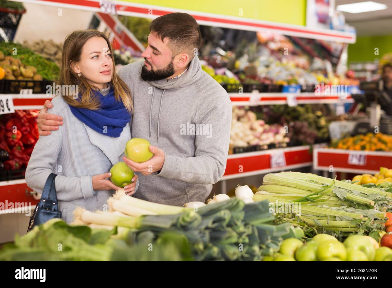 Glad couple choosing vegetables in grocery shop Stock Photo - Alamy