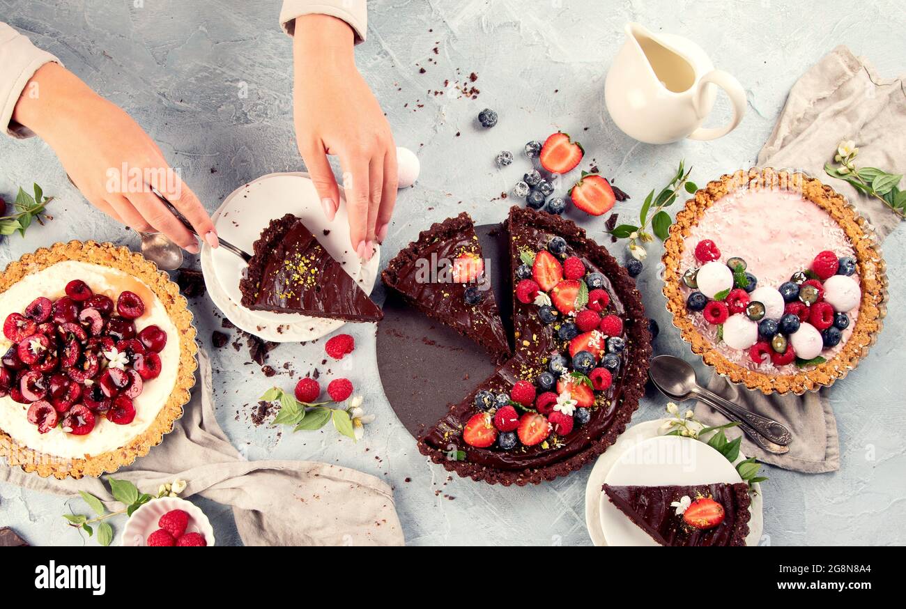 Different types of homemade tarts on light gray background. Top view ...