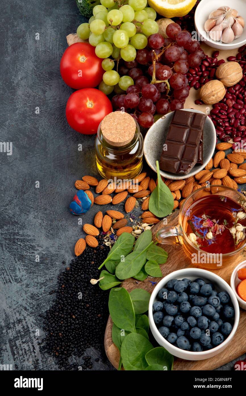 Selection of healthy food high in antioxidants on dark gray background ...