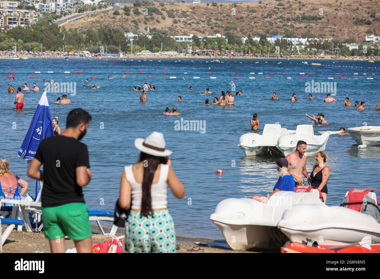 People enjoy the sun and the warm weather at Bodrum beach.One of most ...