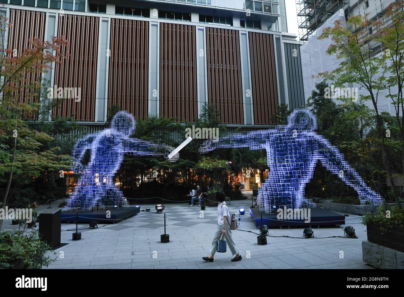 Tokyo, Japan. 21st July, 2021. A woman walks past 'Solidarity and ...