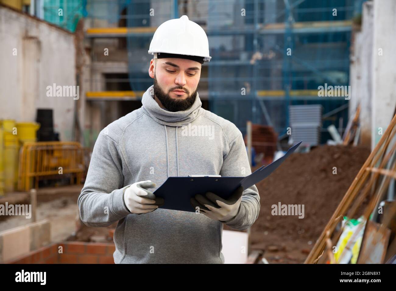Supervisor inspecting process of building overhaul Stock Photo - Alamy