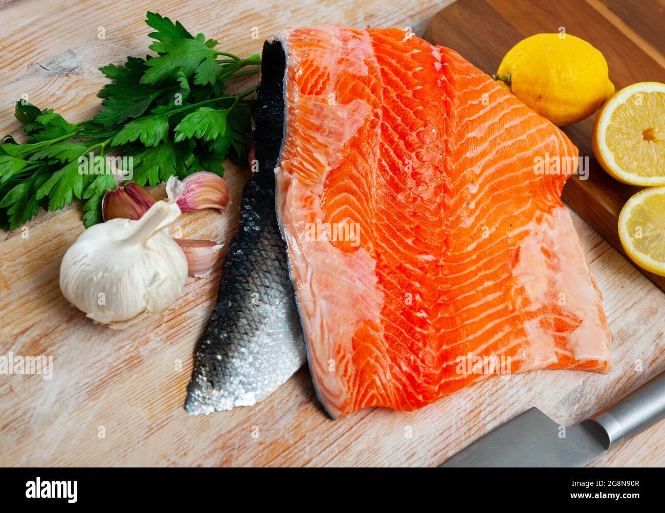 Raw red fish salmon fillet, lemon, parsley Stock Photo - Alamy