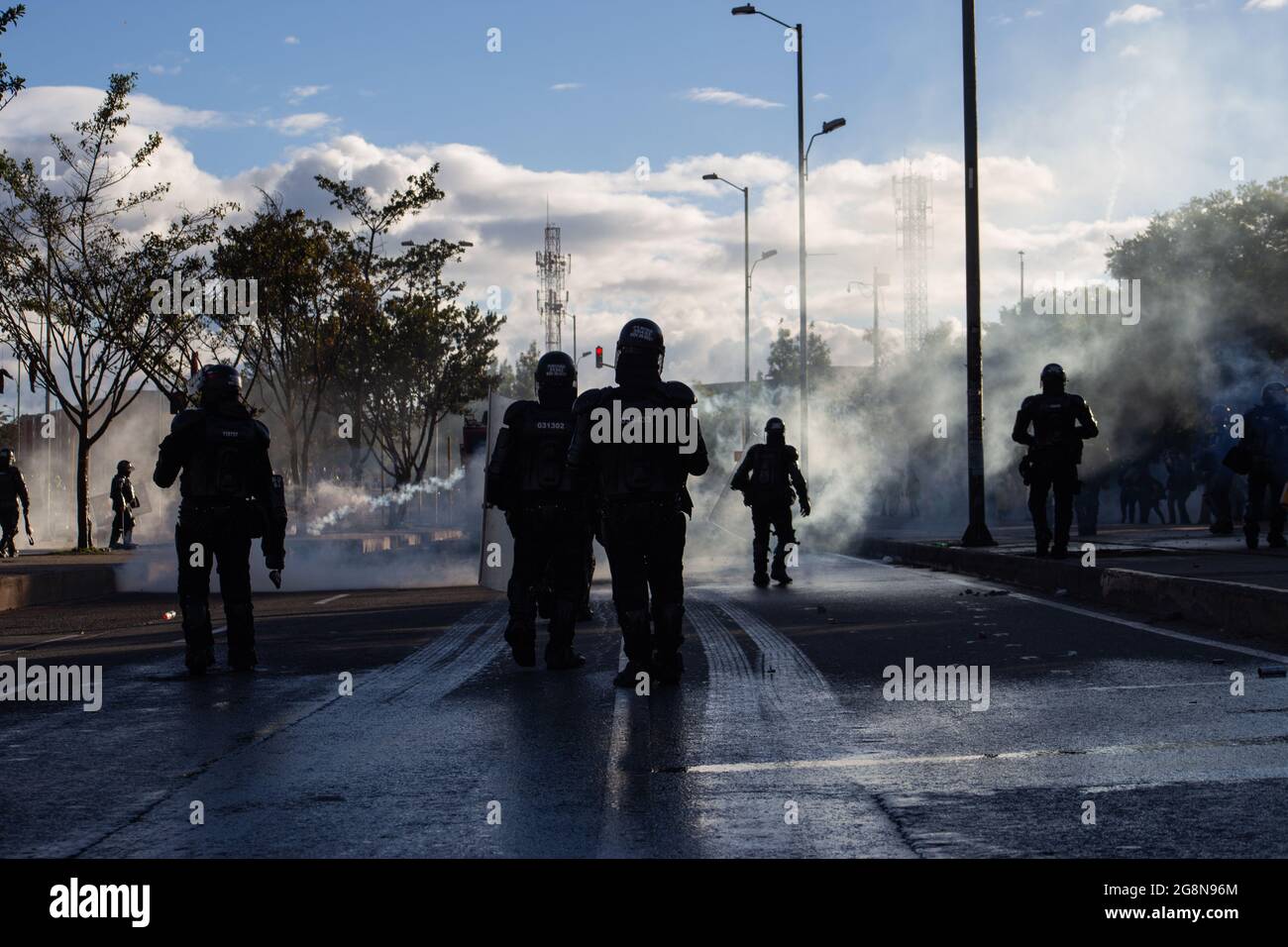 Colombia's riot police stay behind a tear gas cloud during a new day of ...