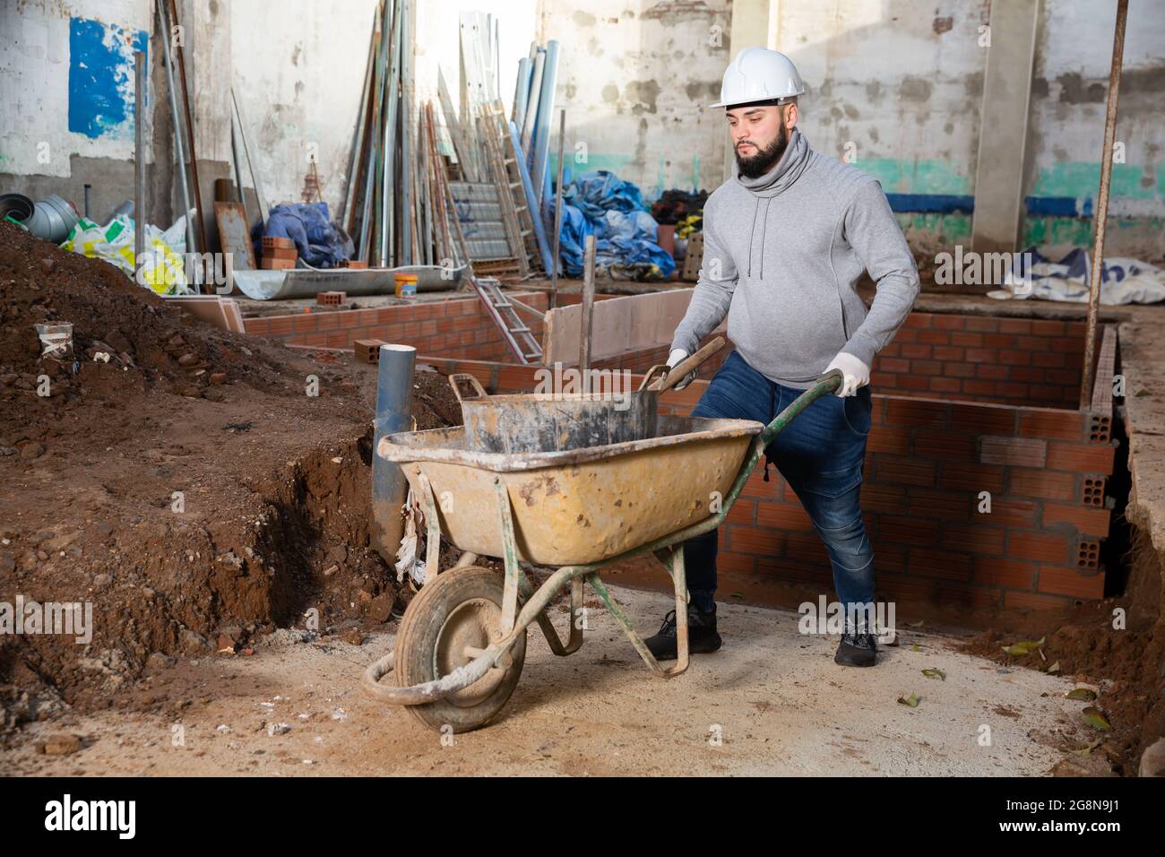 Worker carrying bucket hi-res stock photography and images - Alamy