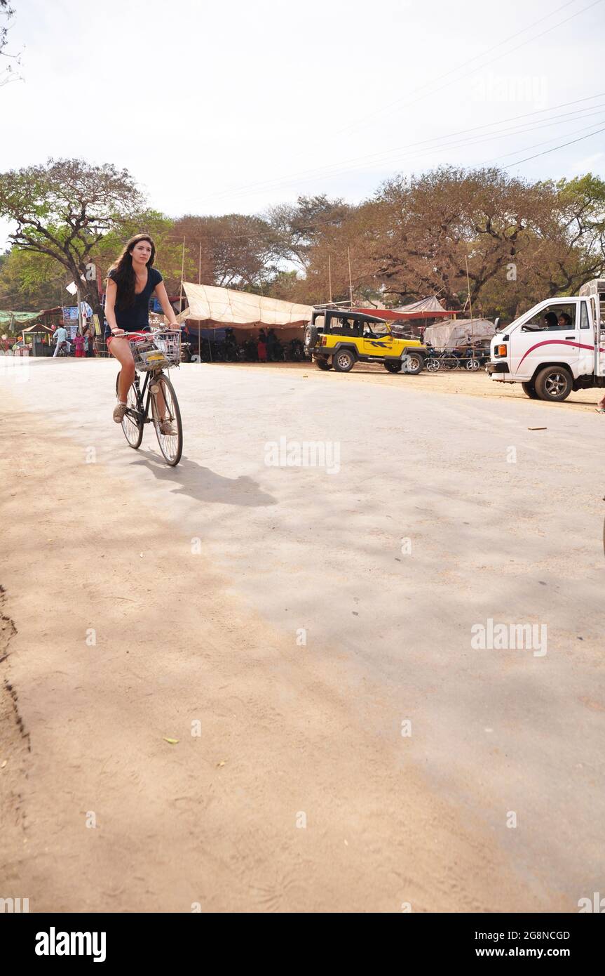 Foreign travelers women biking bicycle on street in street bazaar ...