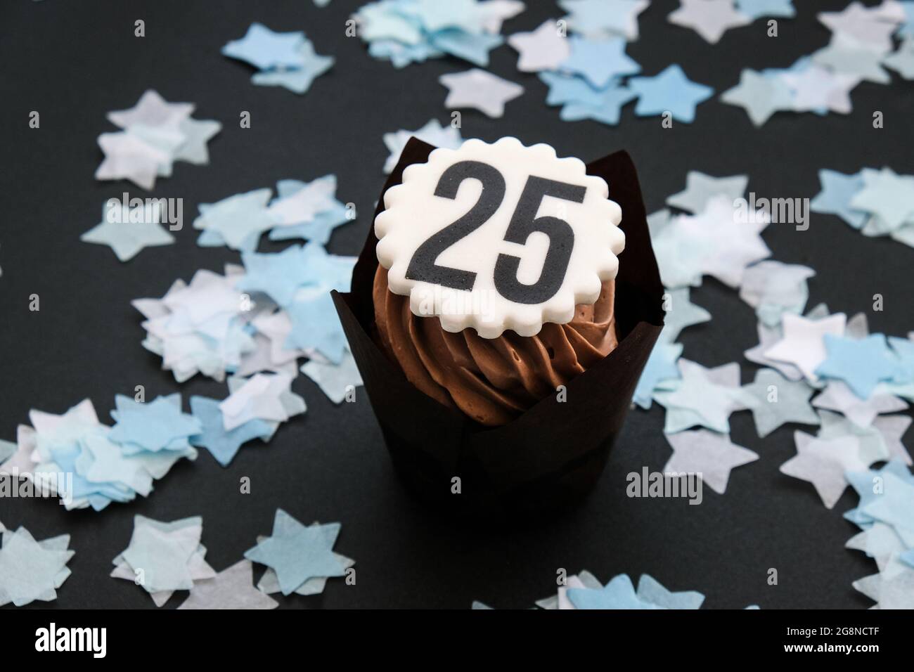 Number 25 on Delicious chocolate cupcake with cream on dark background ...