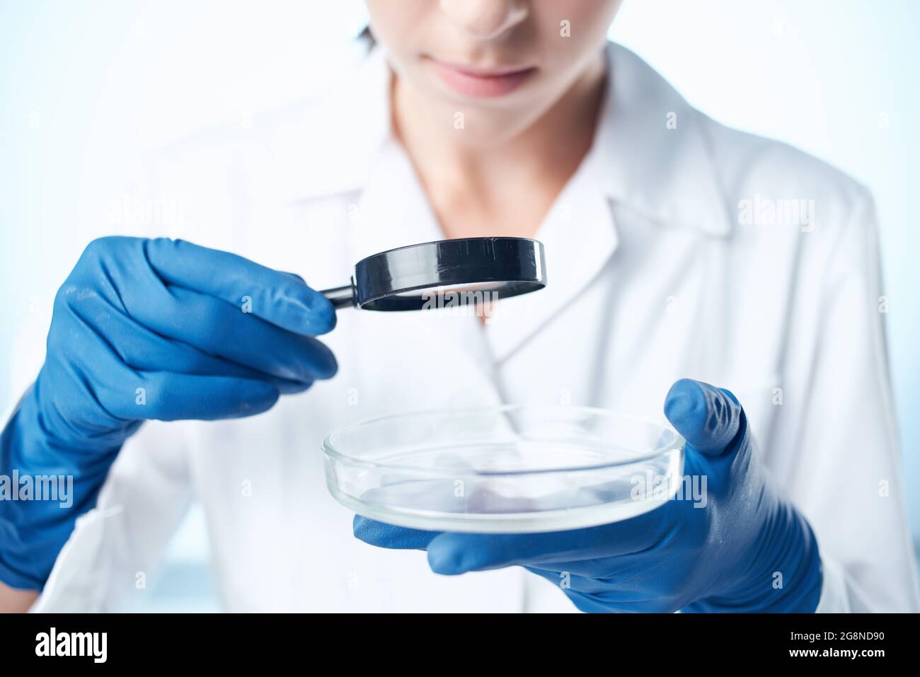 woman scientist looking through a magnifying glass research biology ...