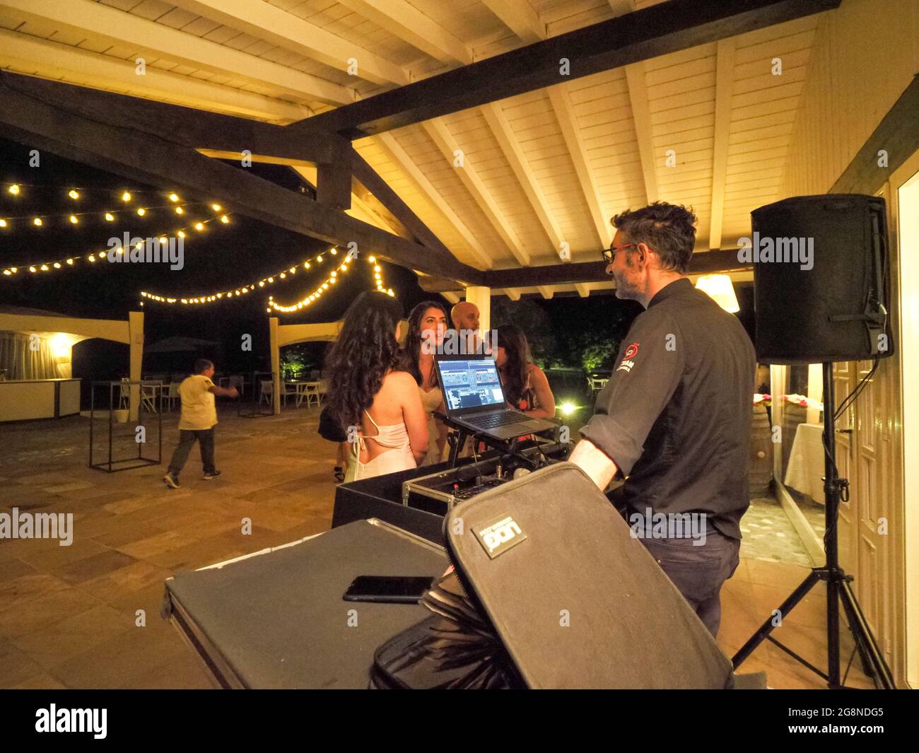 MILANO, ITALY - Jul 07, 2021: A DJ working at a cool nighttime party ...
