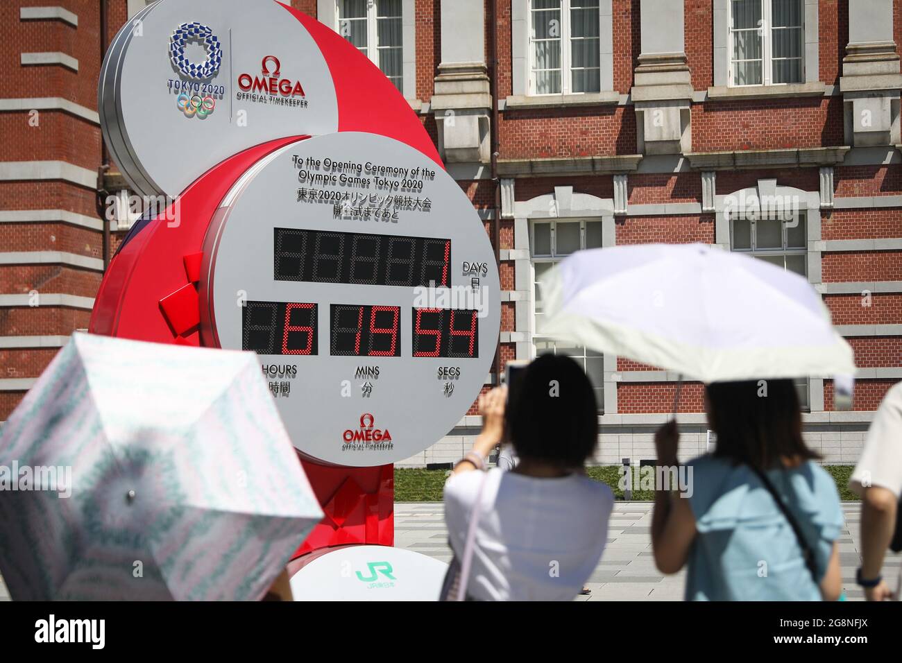 Tokyo, Japan. 22nd July, 2021. People take photos of a countdown clock ...
